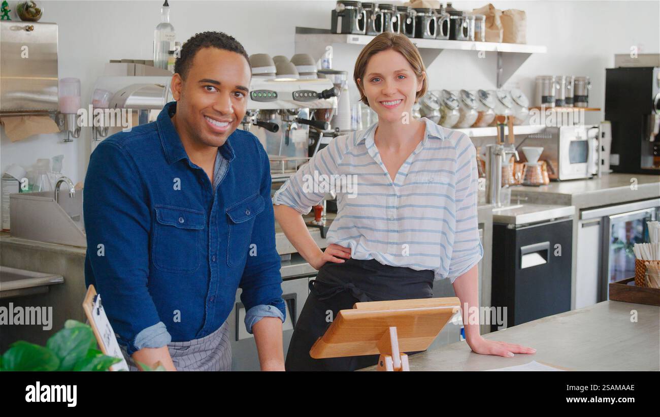 Portrait Of Smiling Male And Female Owners Or Workers Behind Counter In ...