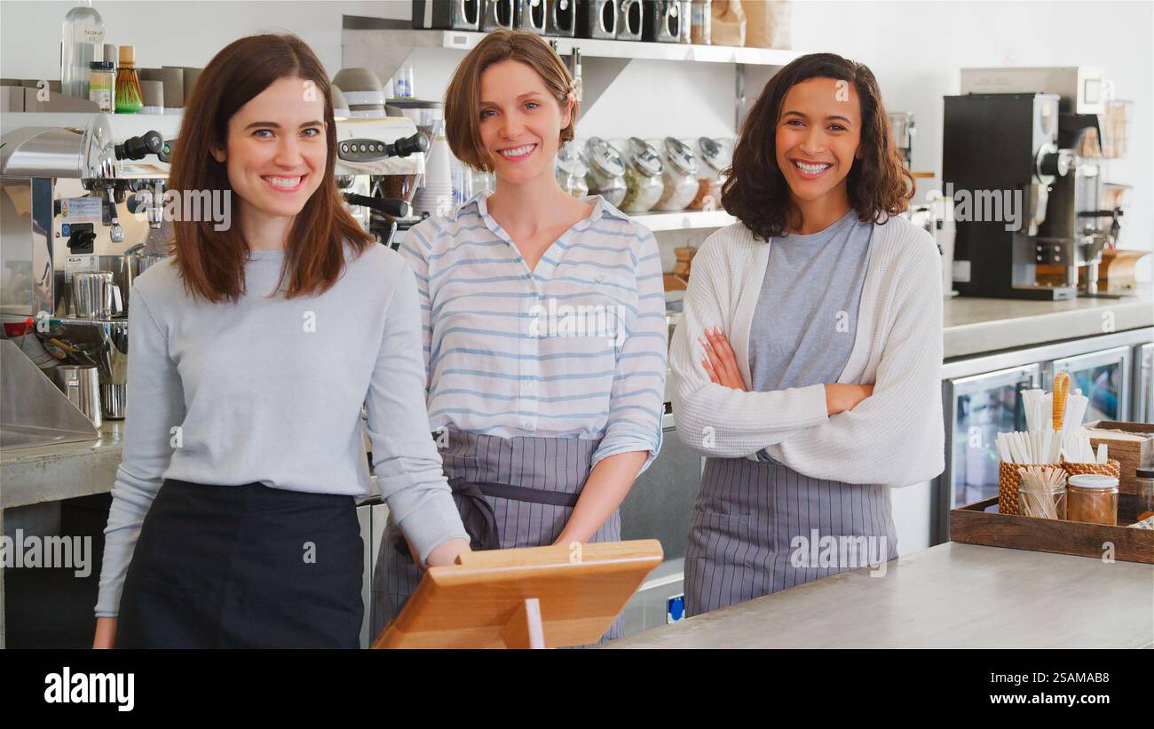 Portrait Of Smiling Female Owners Or Workers Behind Counter In Coffee ...