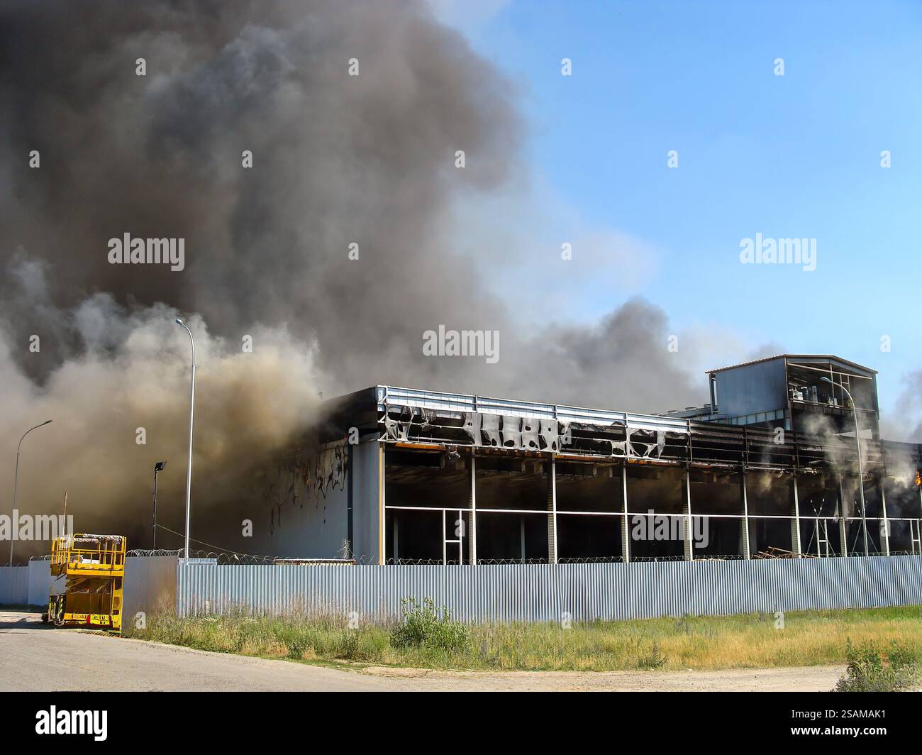 Warehouse fire with thick smoke rising from cold storage building Stock ...
