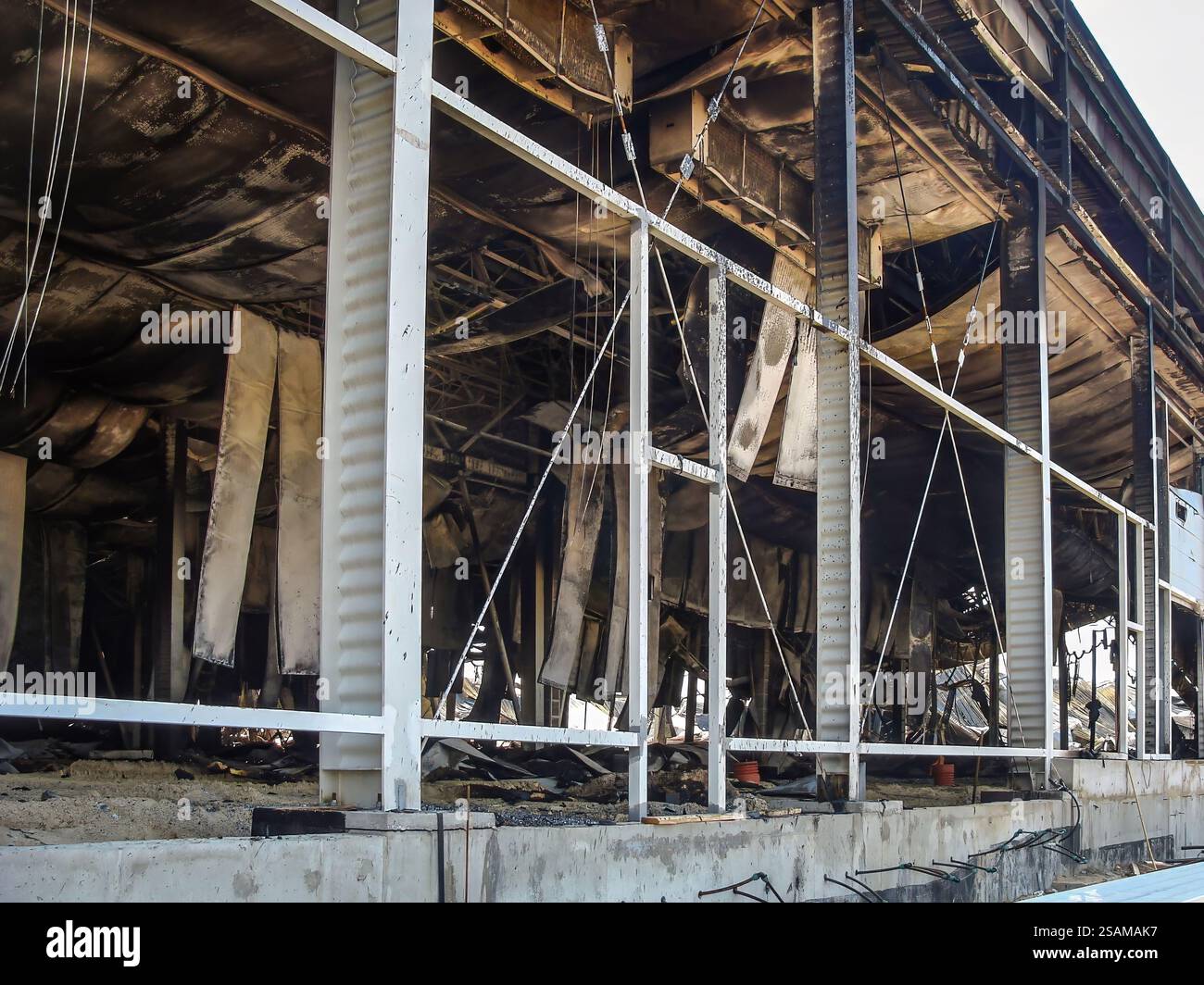 Fire-damaged industrial building featuring a scorched metal frame and ...