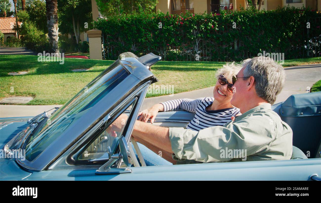 Side View Of Senior Couple On Road Trip Driving In Classic Convertible ...