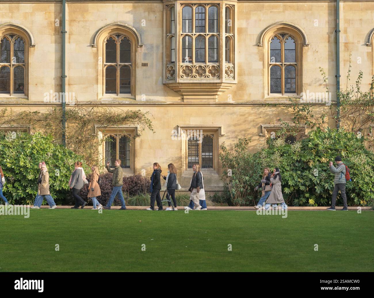 Procession of tourists past the back end of Trinity College, University ...