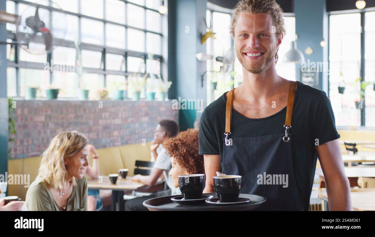 Men carrying drinks hi-res stock photography and images - Alamy