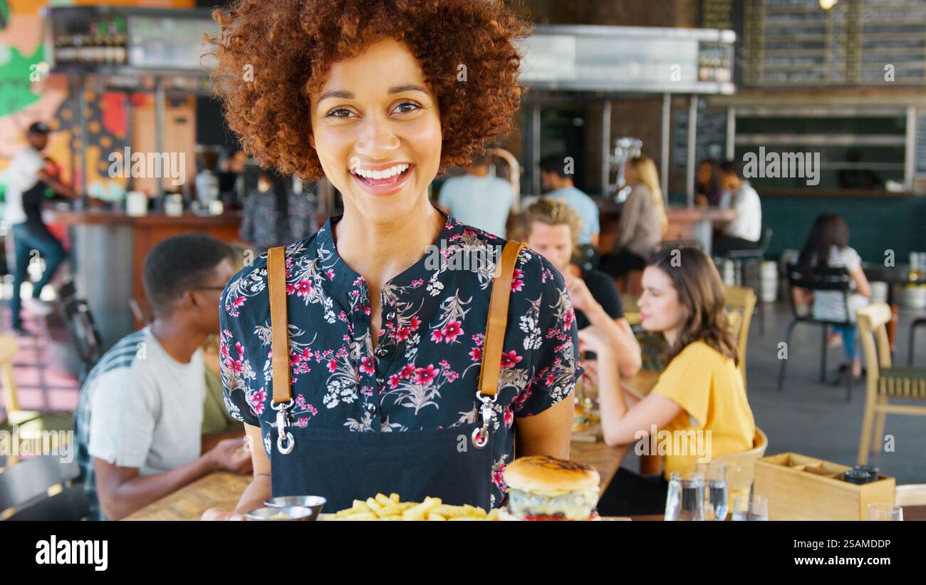 Portrait waitress serving burger hi-res stock photography and images ...