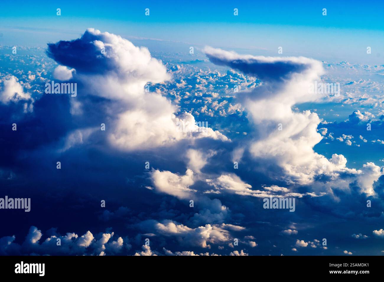 Aerial view of dramatic cloud formations in the sky, with sunlight ...