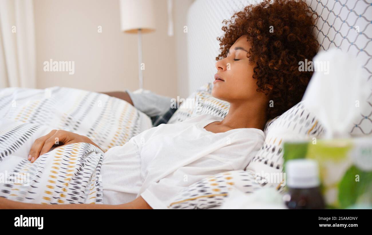 Woman At Home Ill In Bed With Cold With Tissues And Medicine On Bedside ...