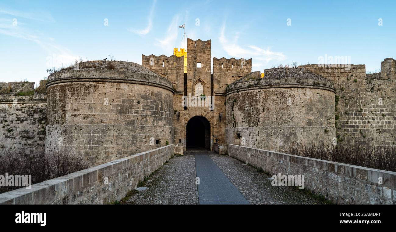 A historic stone fortress with a large entrance, surrounded by thick ...