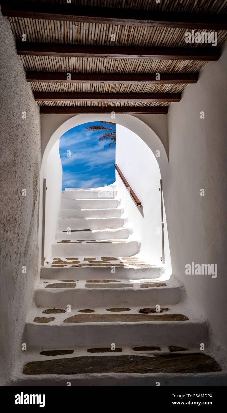 A picturesque staircase leading through an archway, with whitewashed ...