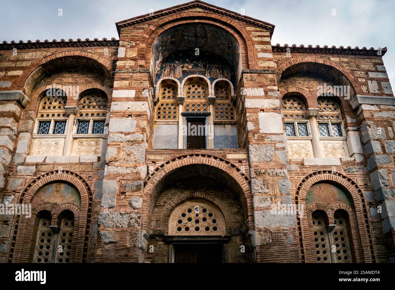 A historical building facade featuring intricate stonework, arched ...