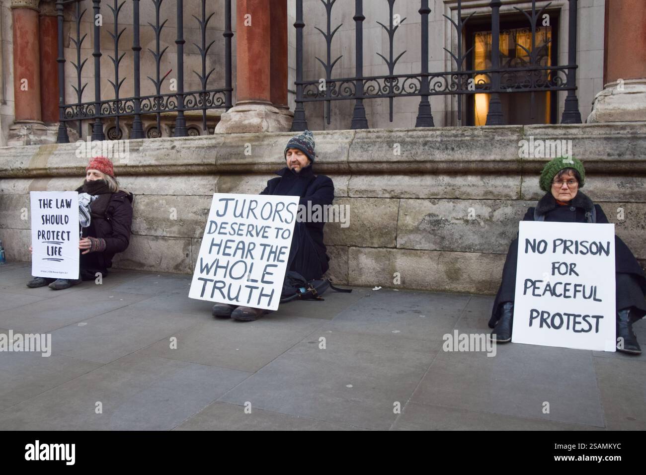 London, UK. 30th Jan, 2025. Protesters sit with placards outside the ...