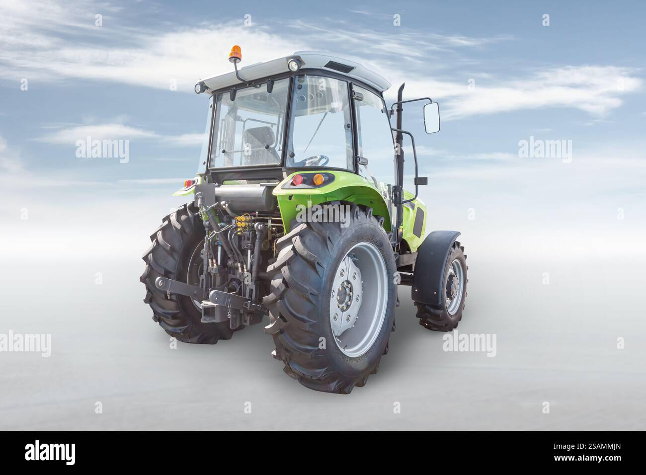 Modern wheeled tractor isolated on bright background with sky Stock ...