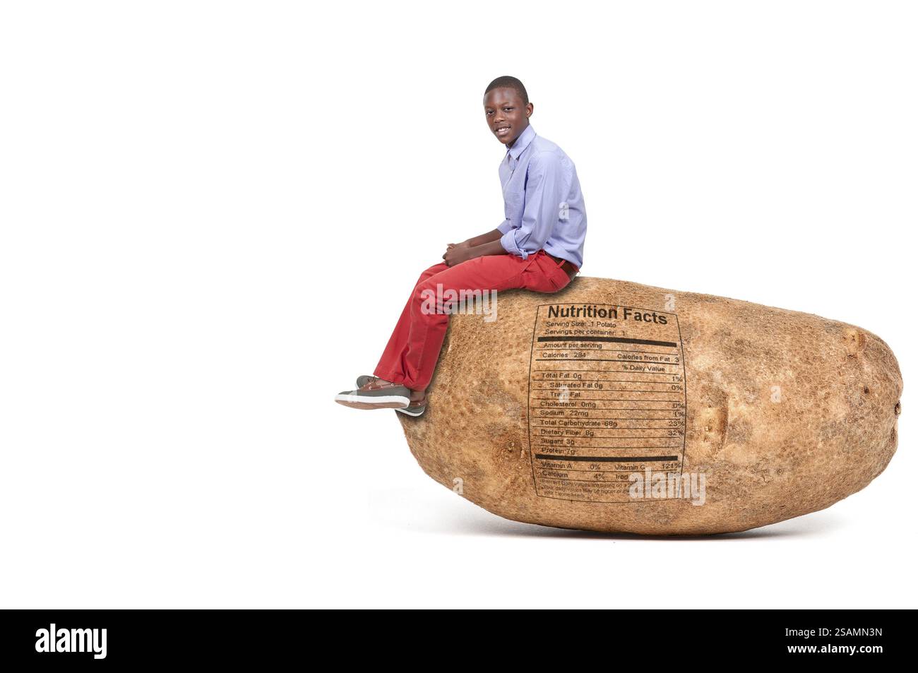 Handsome young black teenager sitting on a potato Stock Photo - Alamy
