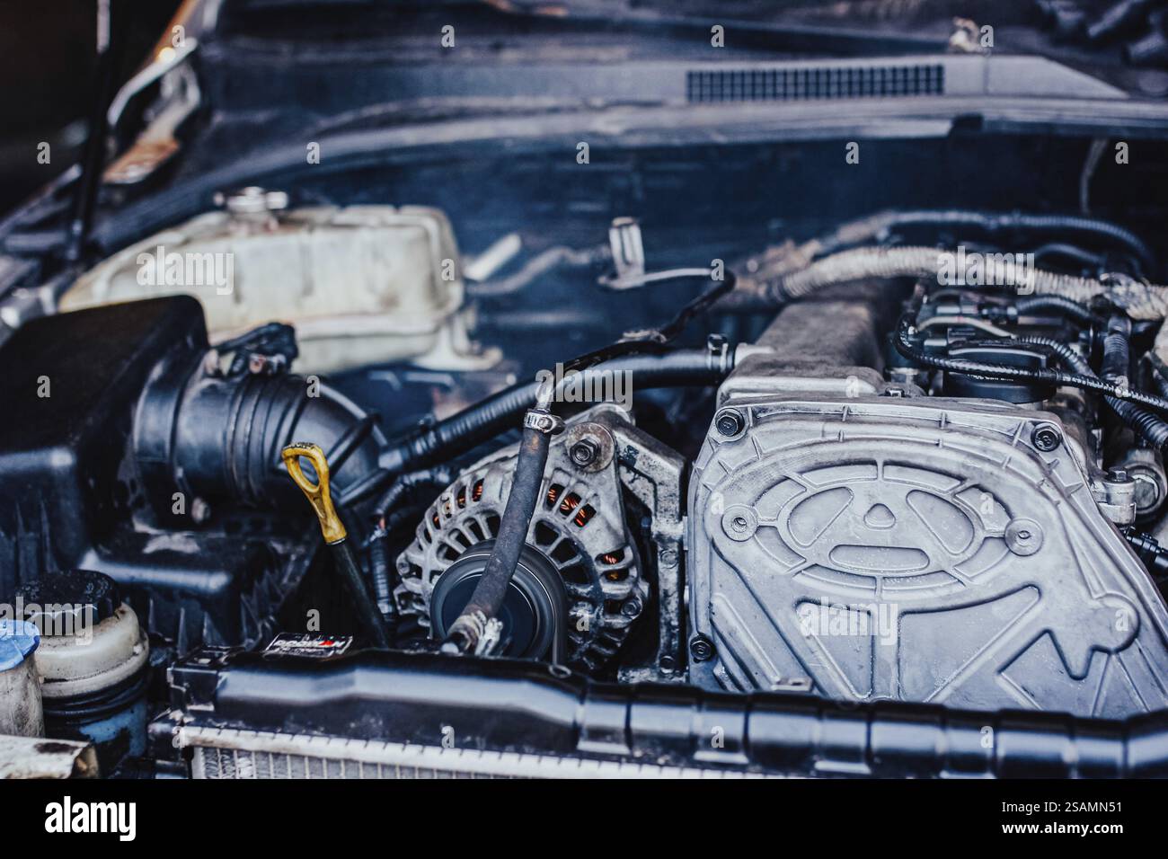 View under the hood of a car, revealing engine components and radiator ...