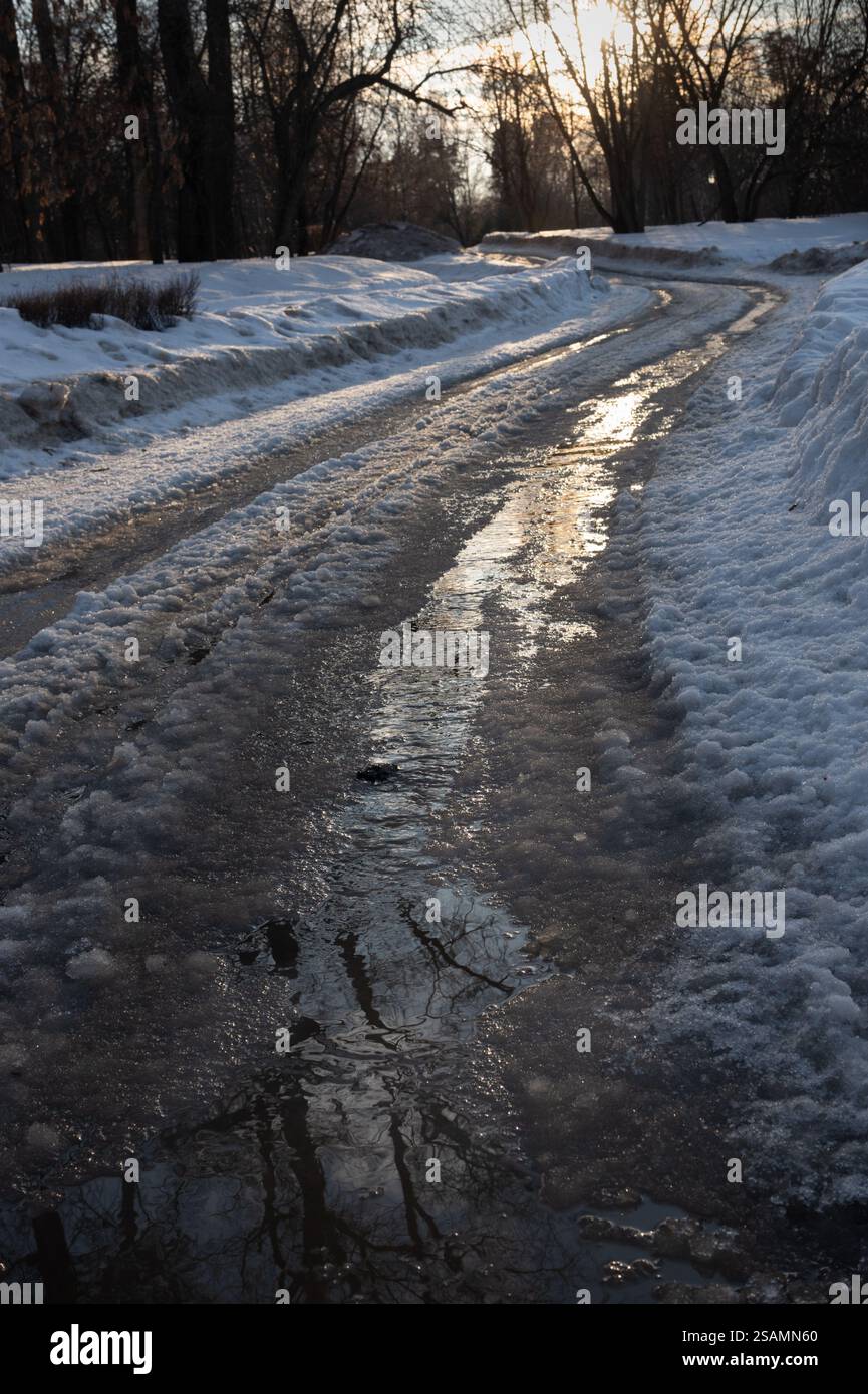 early spring, melting ice and water on a country road Stock Photo - Alamy