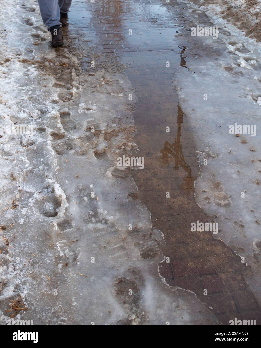 early spring, melting ice and water on a country road Stock Photo - Alamy