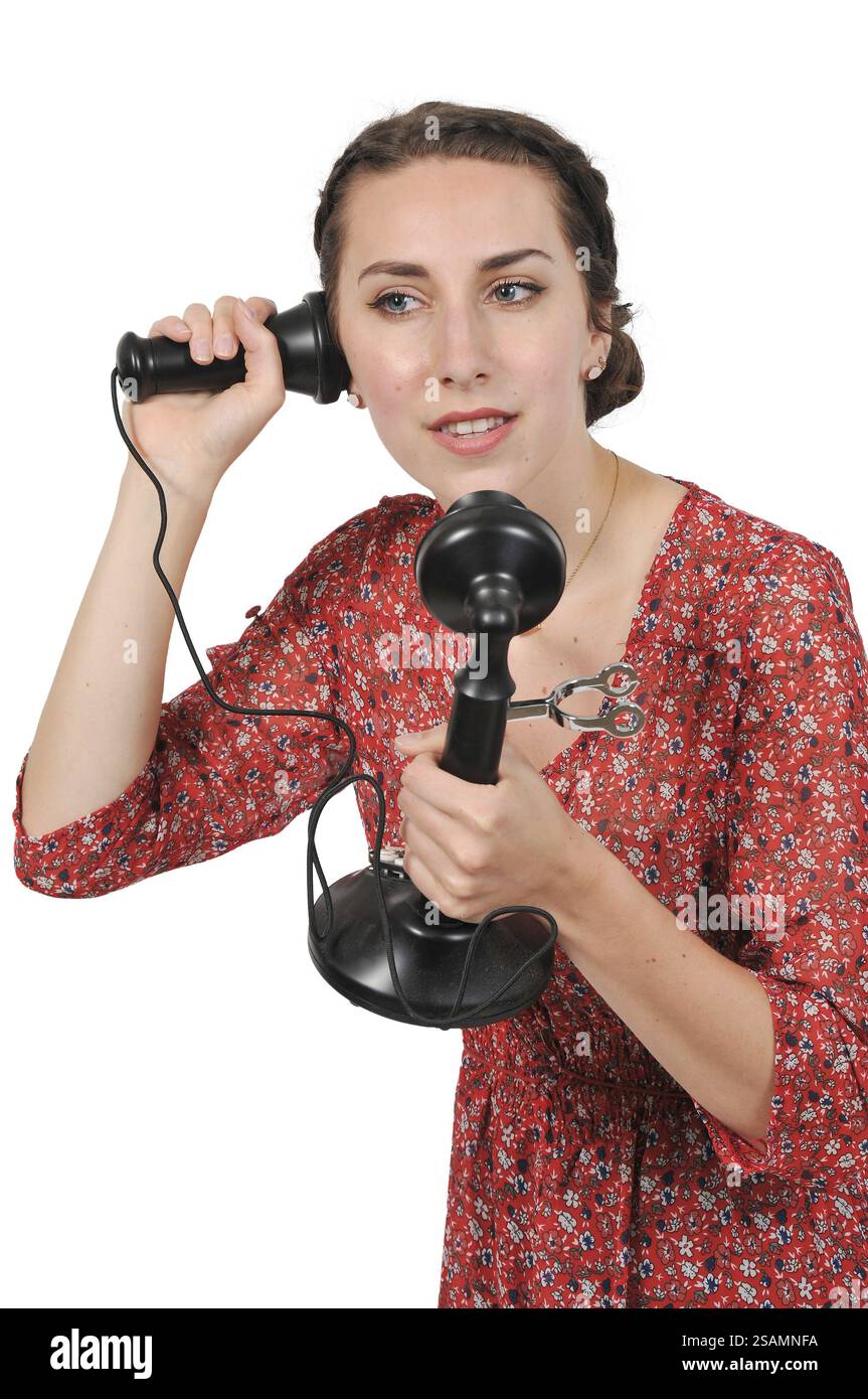 Woman using an old timey vintage candlestick phone Stock Photo - Alamy