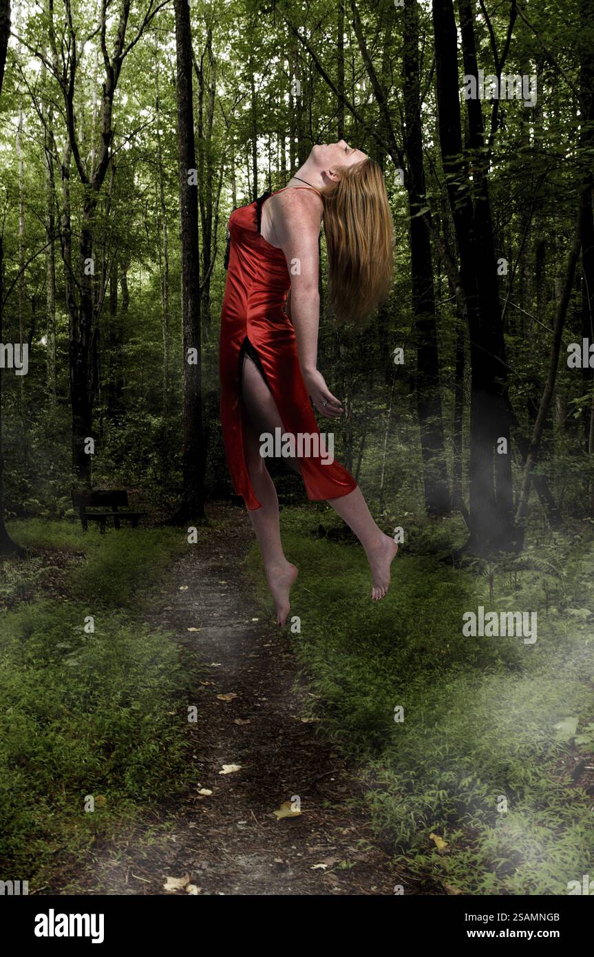 Beautiful young woman floating in the air Stock Photo - Alamy