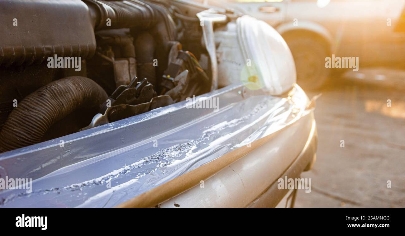 Sunlit car engine visible under open hood, hinting at repair Stock ...