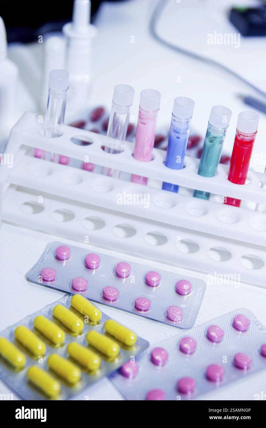 Pills and lively colored test tubes in a scientific laboratory Stock ...