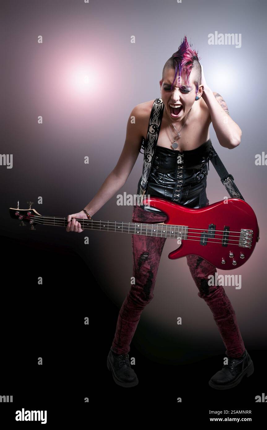 Beautiful woman punk rocker with an electric bass guitar Stock Photo ...