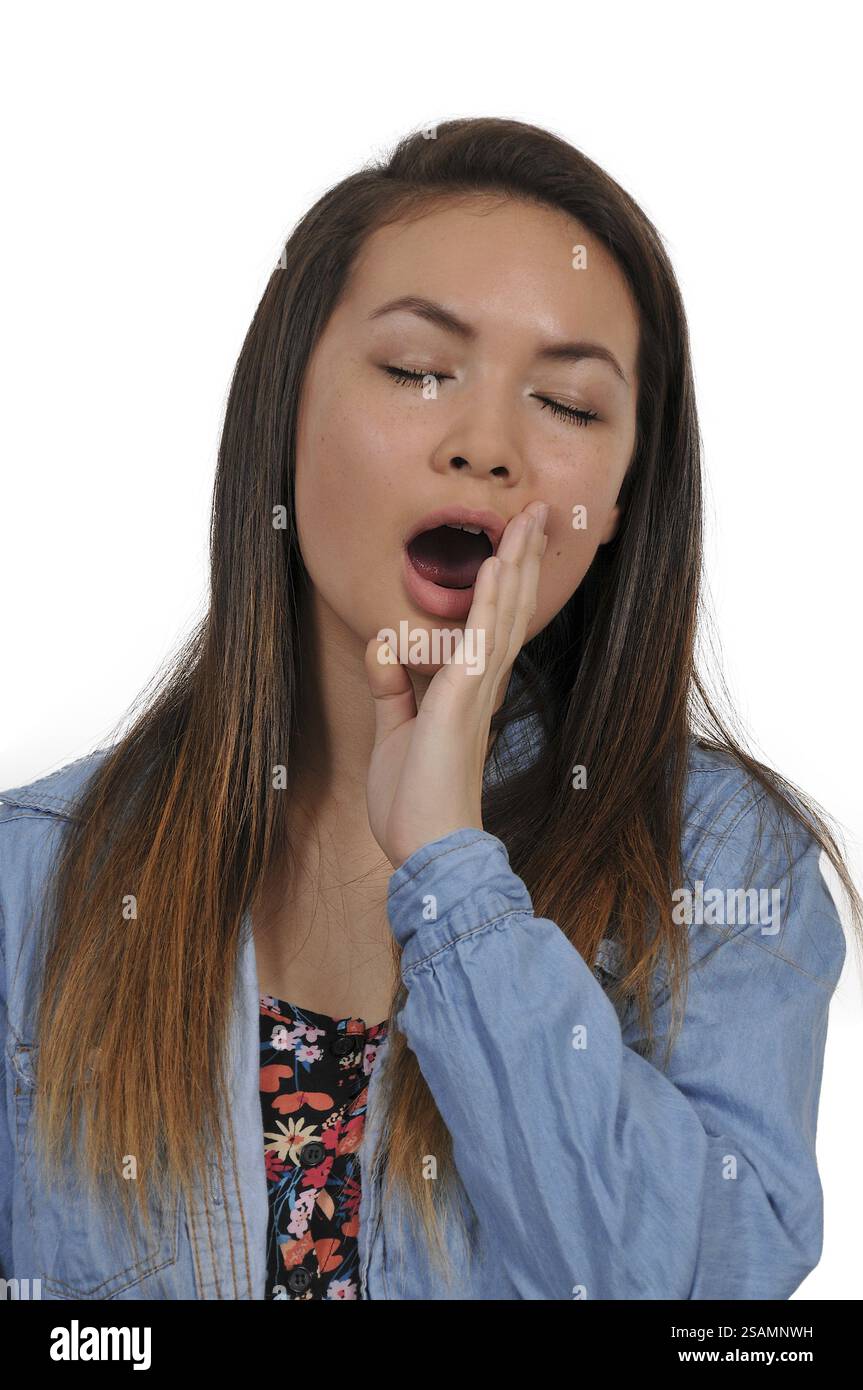 Beautiful woman yawning because she is tired Stock Photo - Alamy