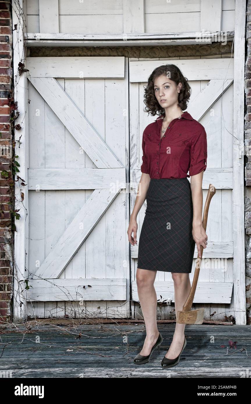 Beautiful possessed woman in a trace holding an axe Stock Photo - Alamy