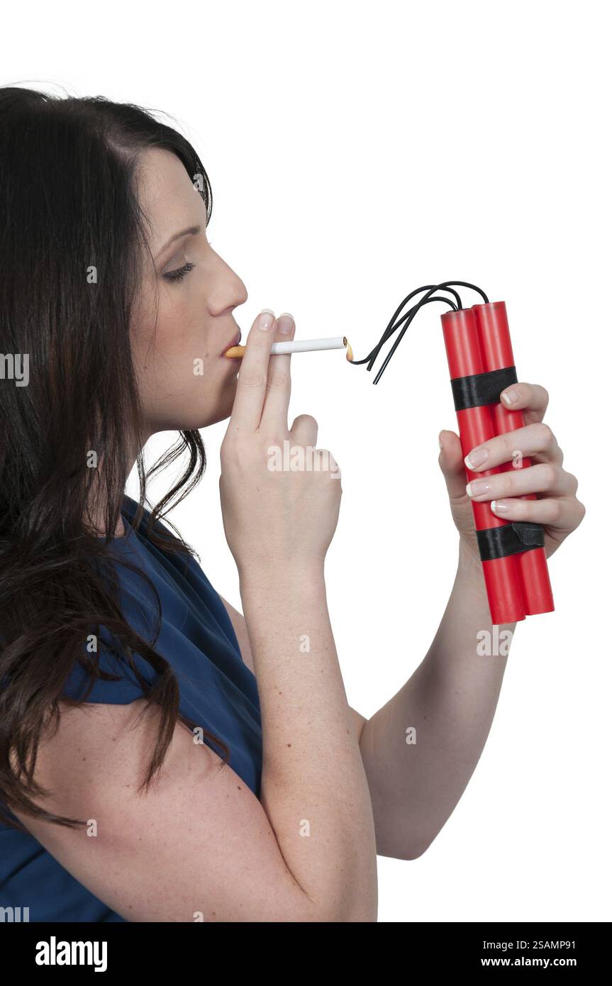 Beautiful woman lighting a cigarette with dynamite Stock Photo - Alamy
