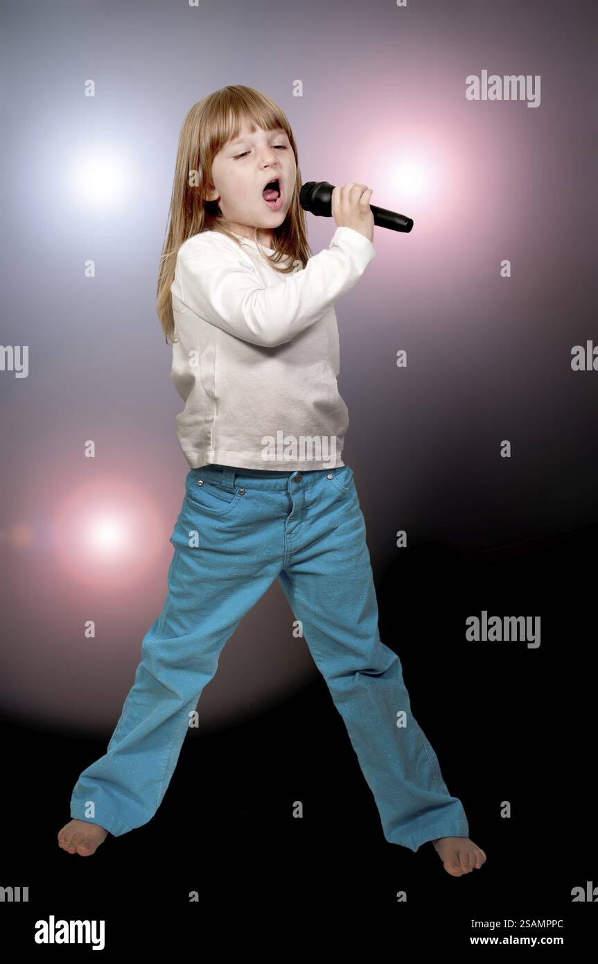 Beautiful girl singer performing at a concert Stock Photo - Alamy