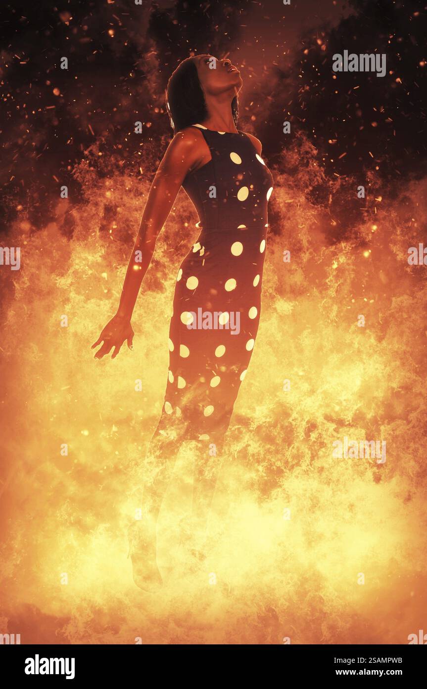 Beautiful woman standing in the midst of a fire Stock Photo - Alamy