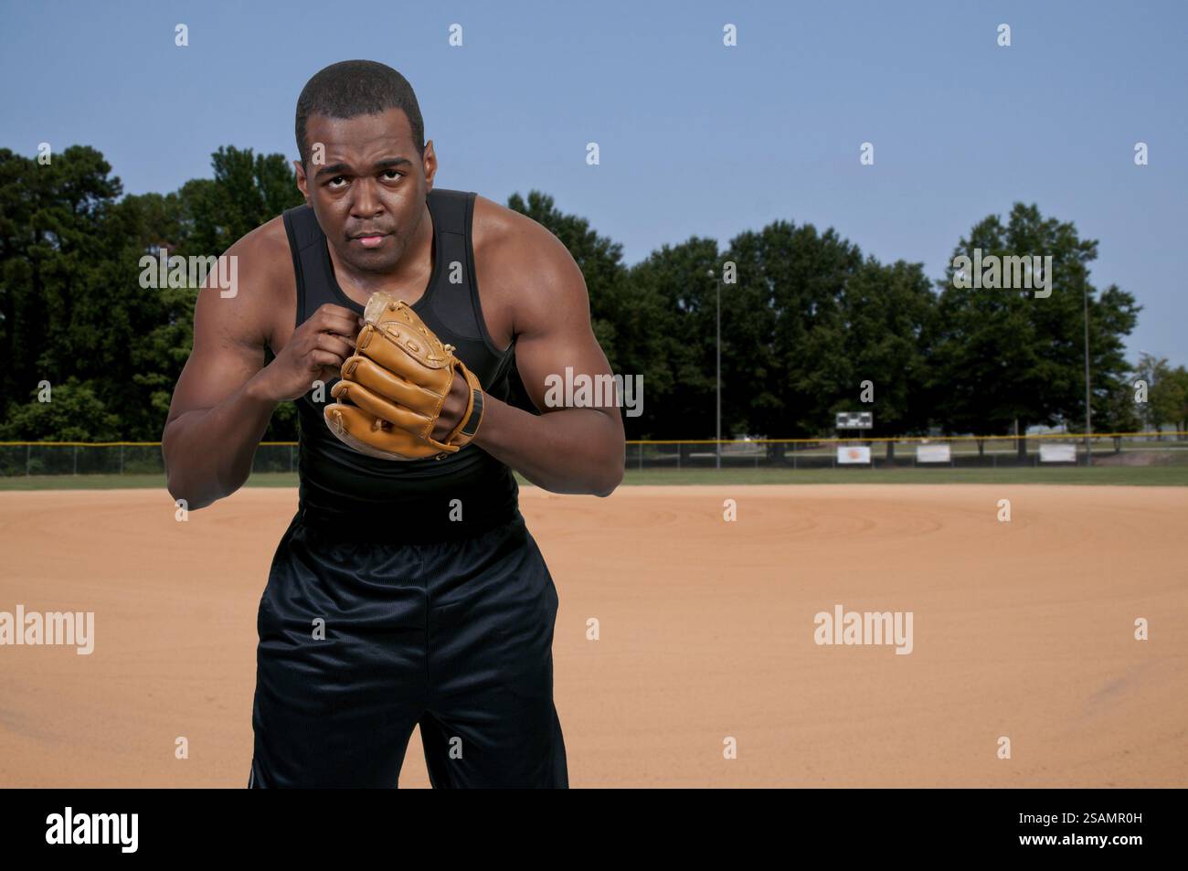 A black African American man baseball pitcher getting ready to throw a ...