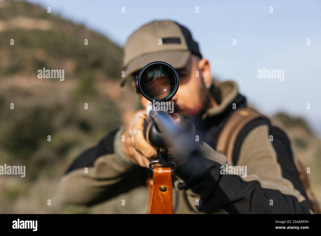 Hunter aiming with rifle scope in nature Stock Photo - Alamy