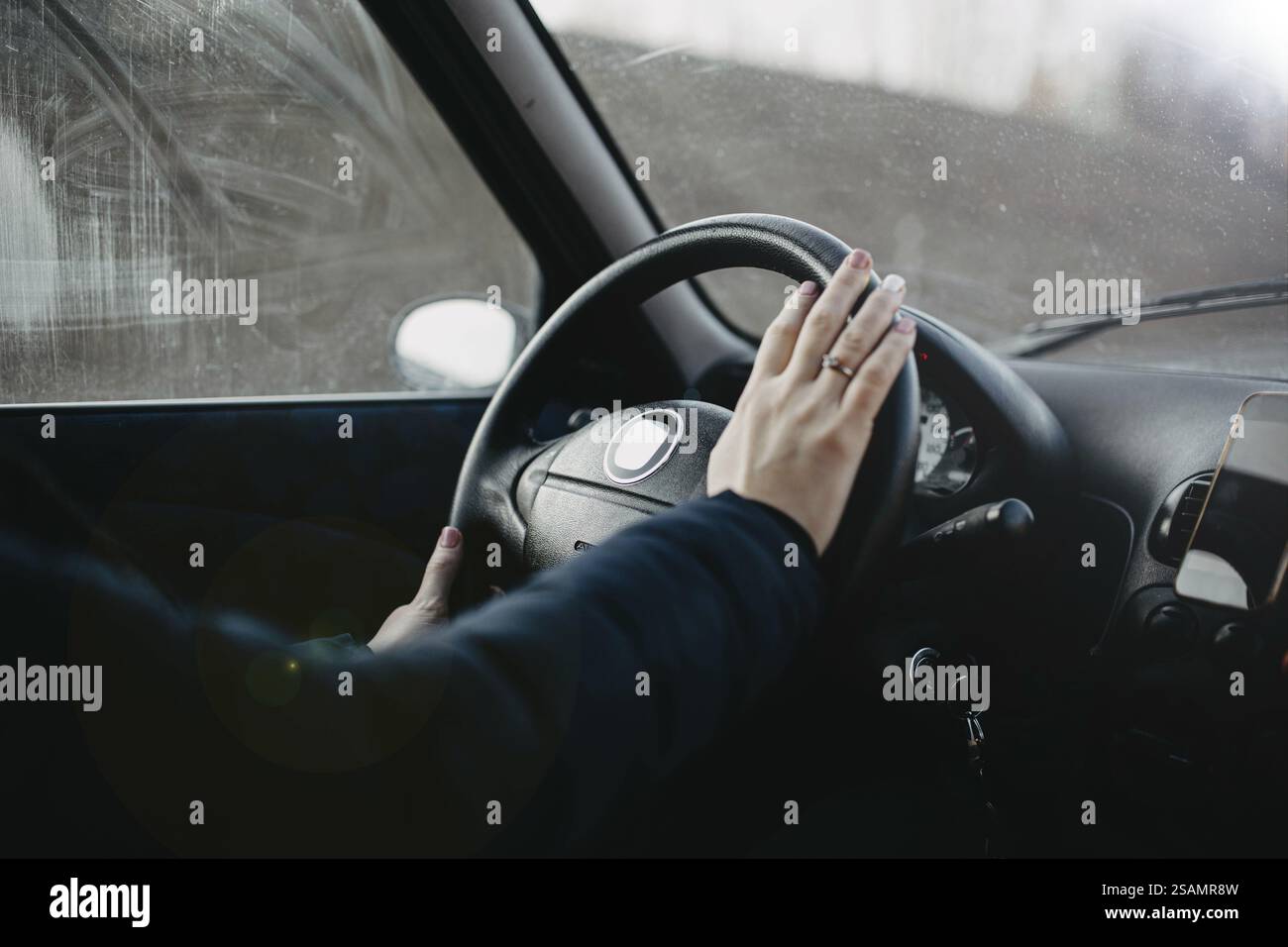 Hand resting on a steering wheel as if about to press the horn Stock ...