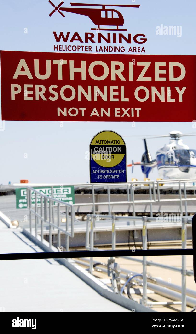 A door warning of a helicopter landing area Stock Photo - Alamy