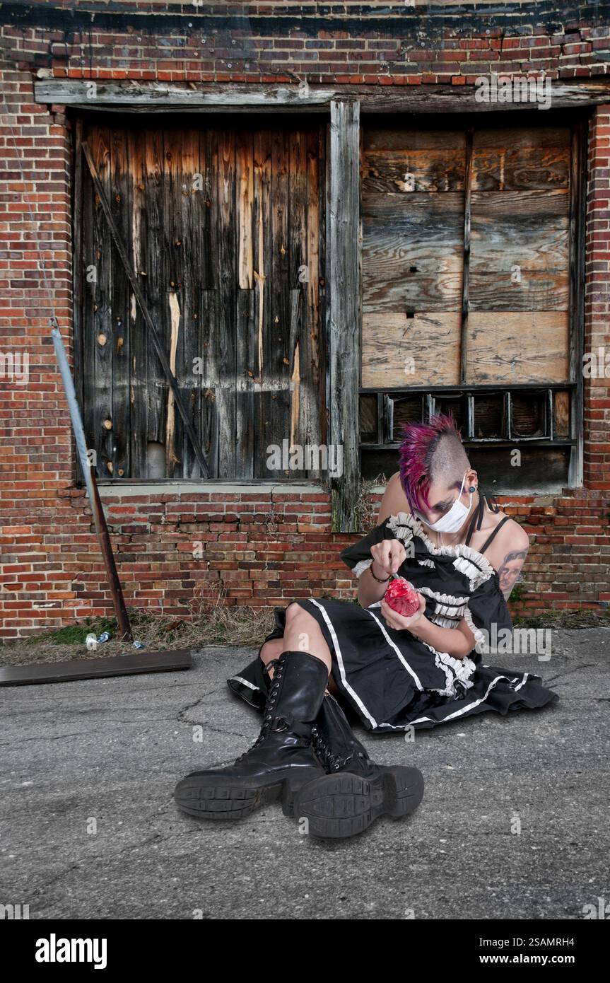 Beautiful gohic woman doing surgery on a heart Stock Photo - Alamy