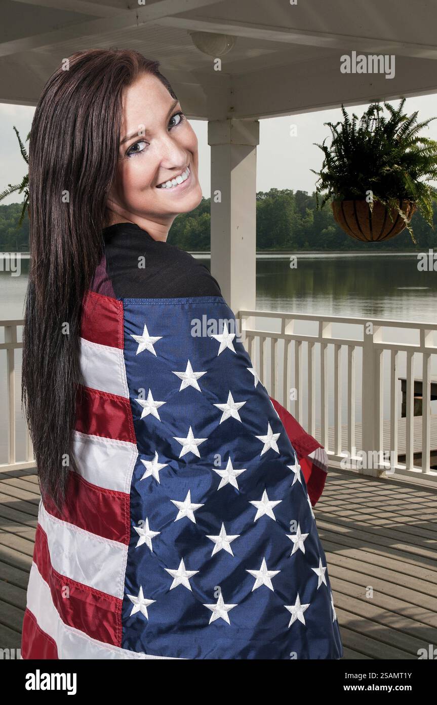 Beautiful young woman wrapped in a flag Stock Photo - Alamy