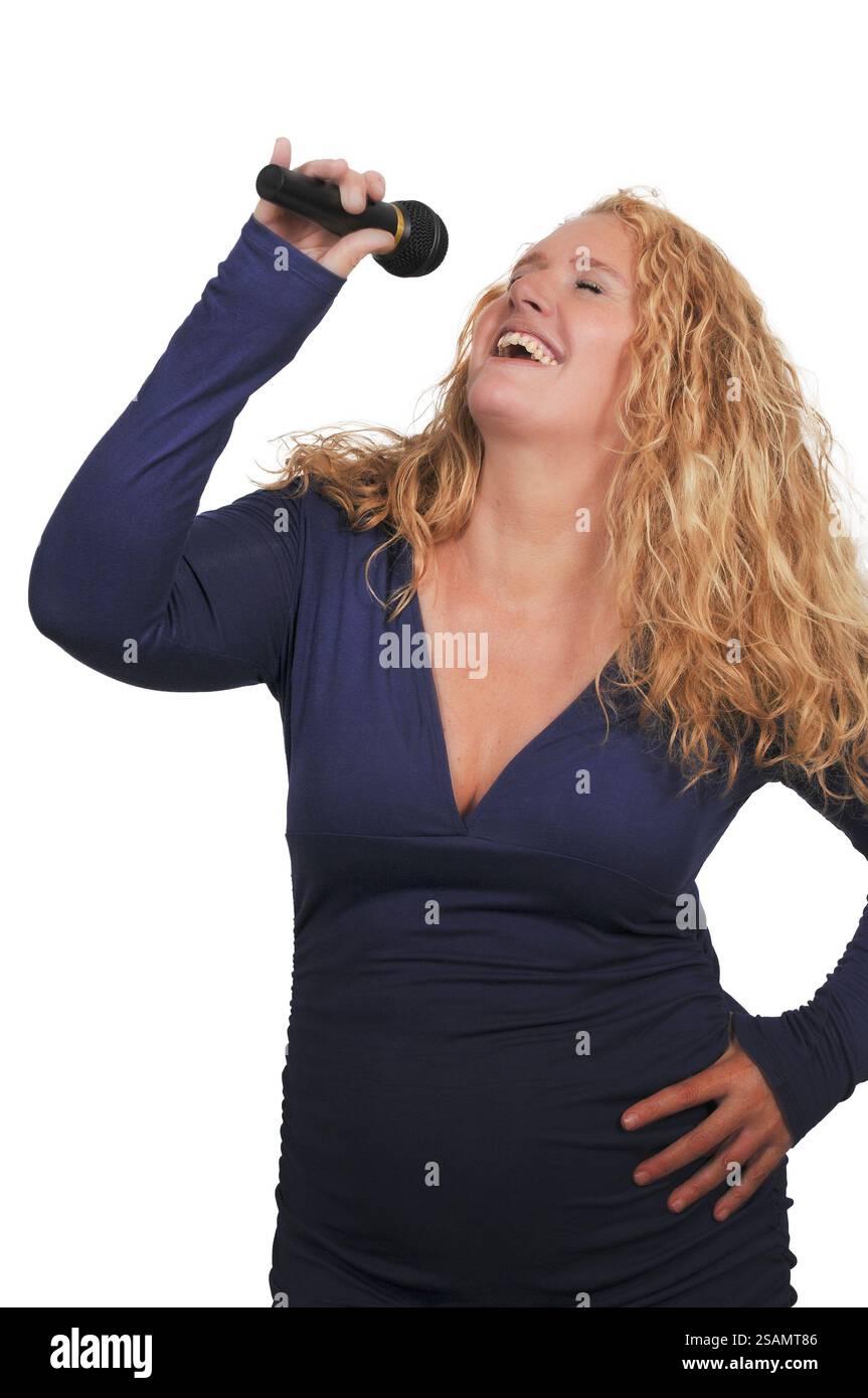 Middle age woman singer performing at a concert Stock Photo - Alamy
