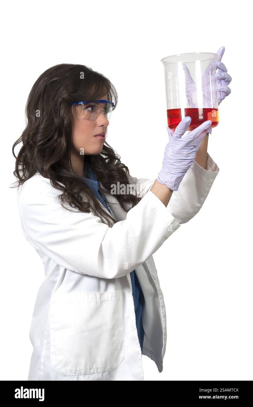 Beautiful woman scientist investigating a glass beaker Stock Photo - Alamy