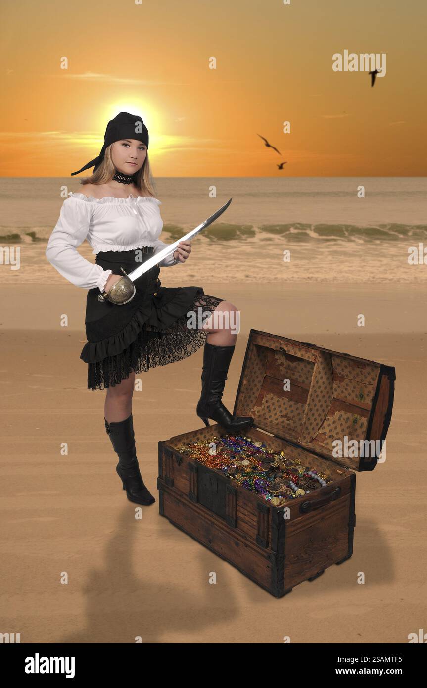 Beautiful young woman pirate opening a treasure chest Stock Photo - Alamy