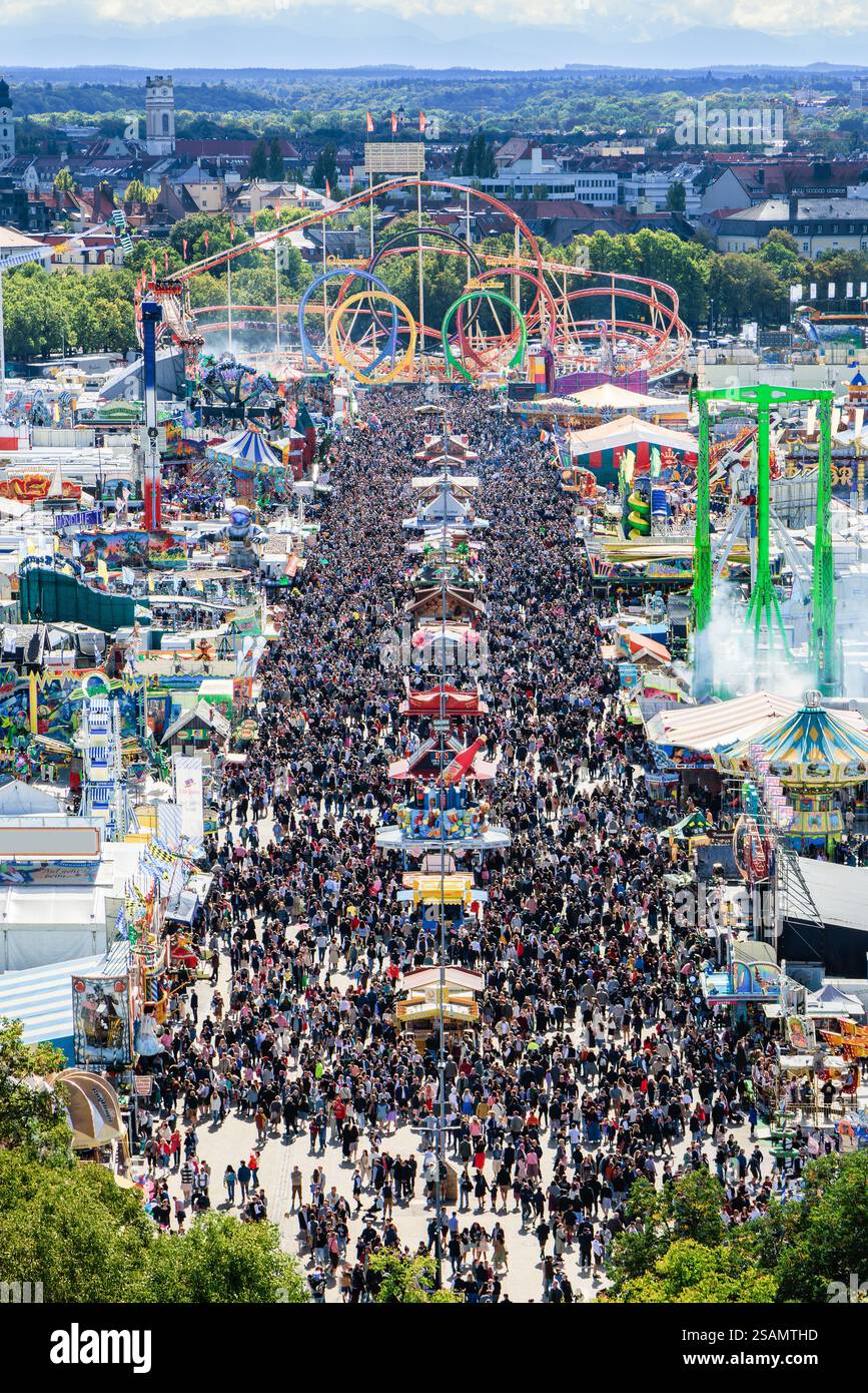 Dense crowd of visitors at the Oktoberfest in Munich with numerous ...
