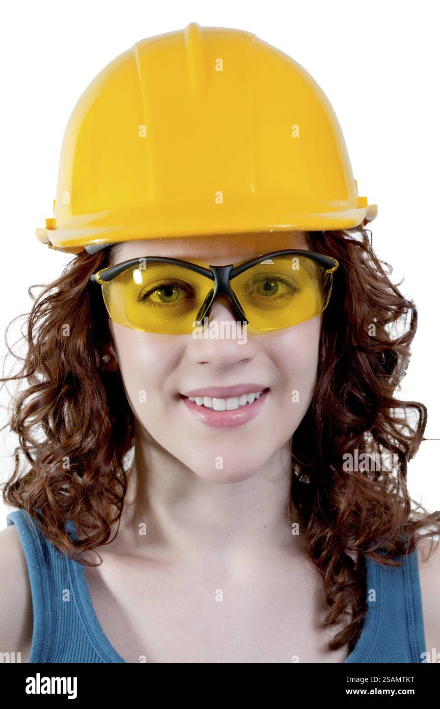 A Female Construction Worker wearing a hard hat and safety glasses Stock Photo - Alamy