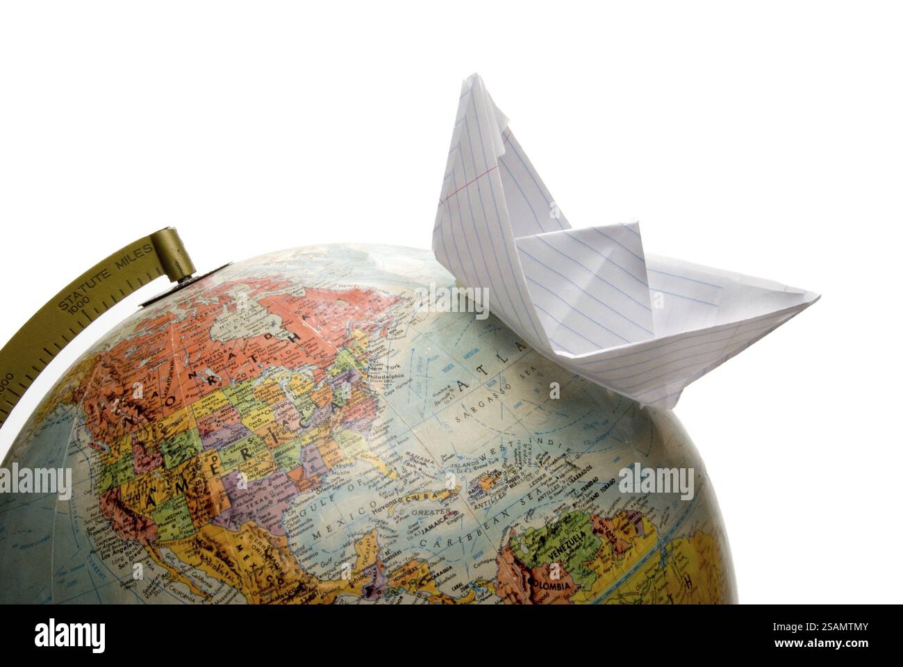 A boat sailing across a globe of the world Stock Photo - Alamy