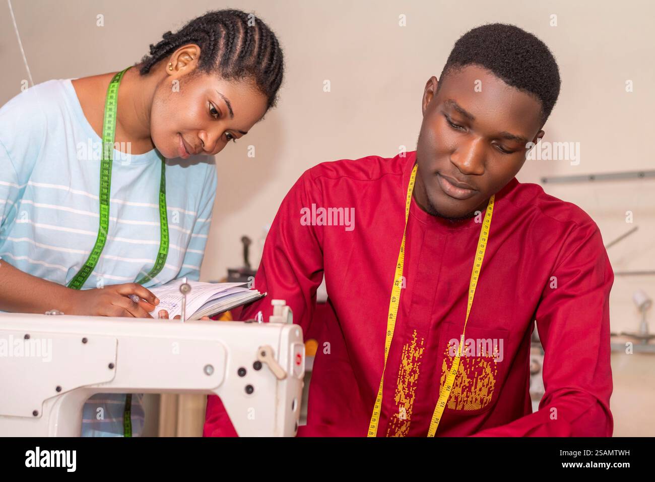 Tailor teaching skill discussing hi-res stock photography and images ...