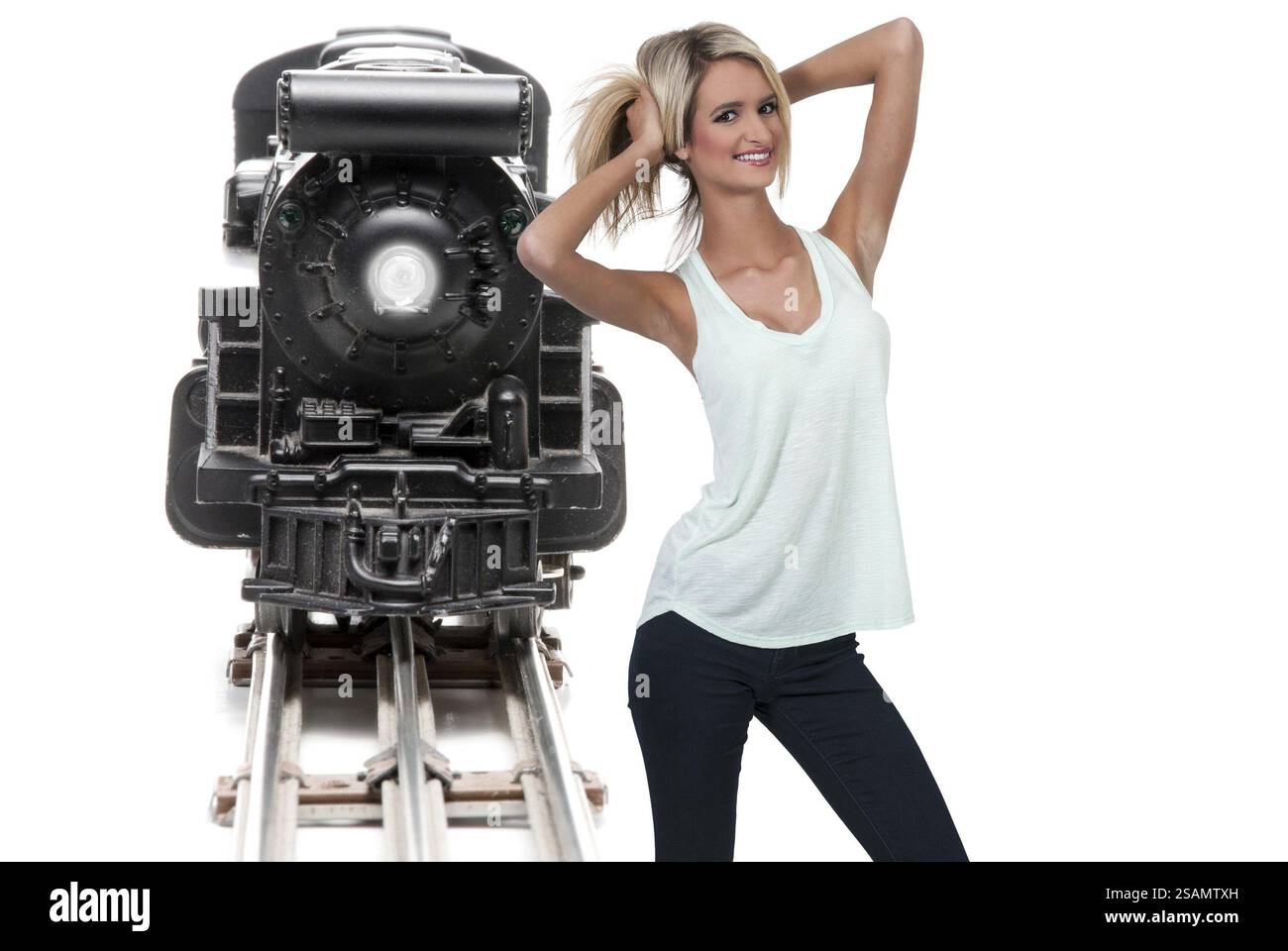 Woman with a replica of a steam powered train Stock Photo - Alamy