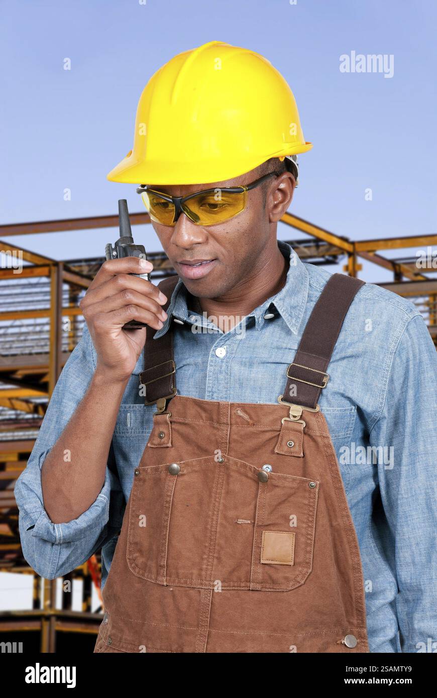 Handsome black man construction worker talking on a walkie talkie Stock ...