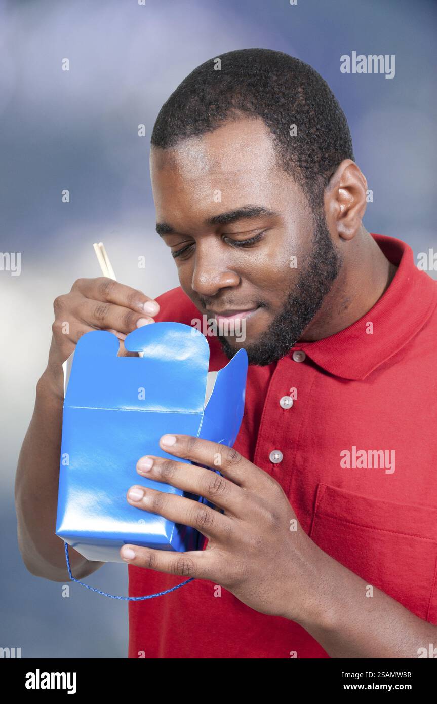 Black African American man eating Chinese or Japanese Asian food Stock ...