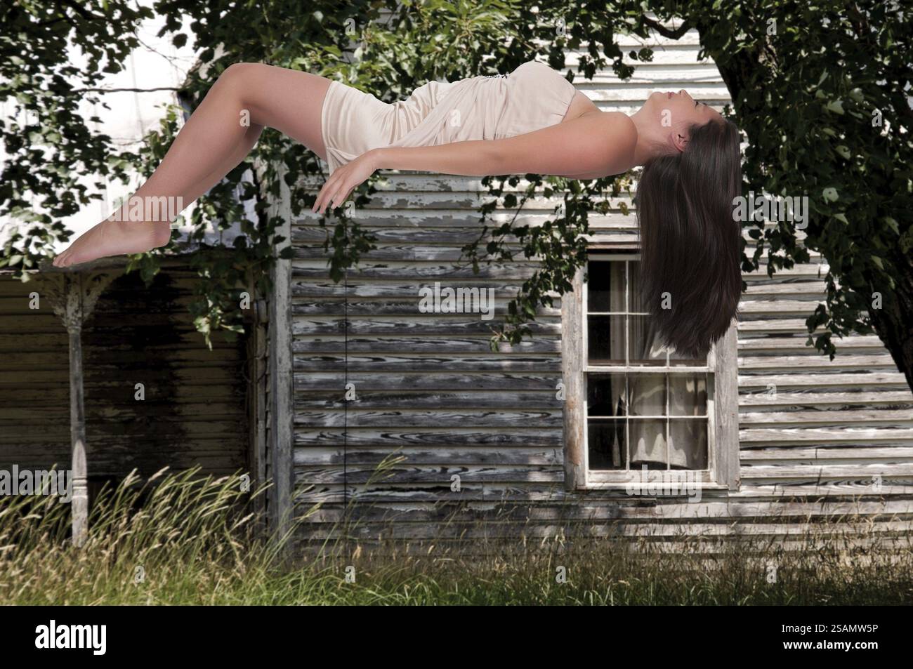 Beautiful young woman floating in the air Stock Photo - Alamy