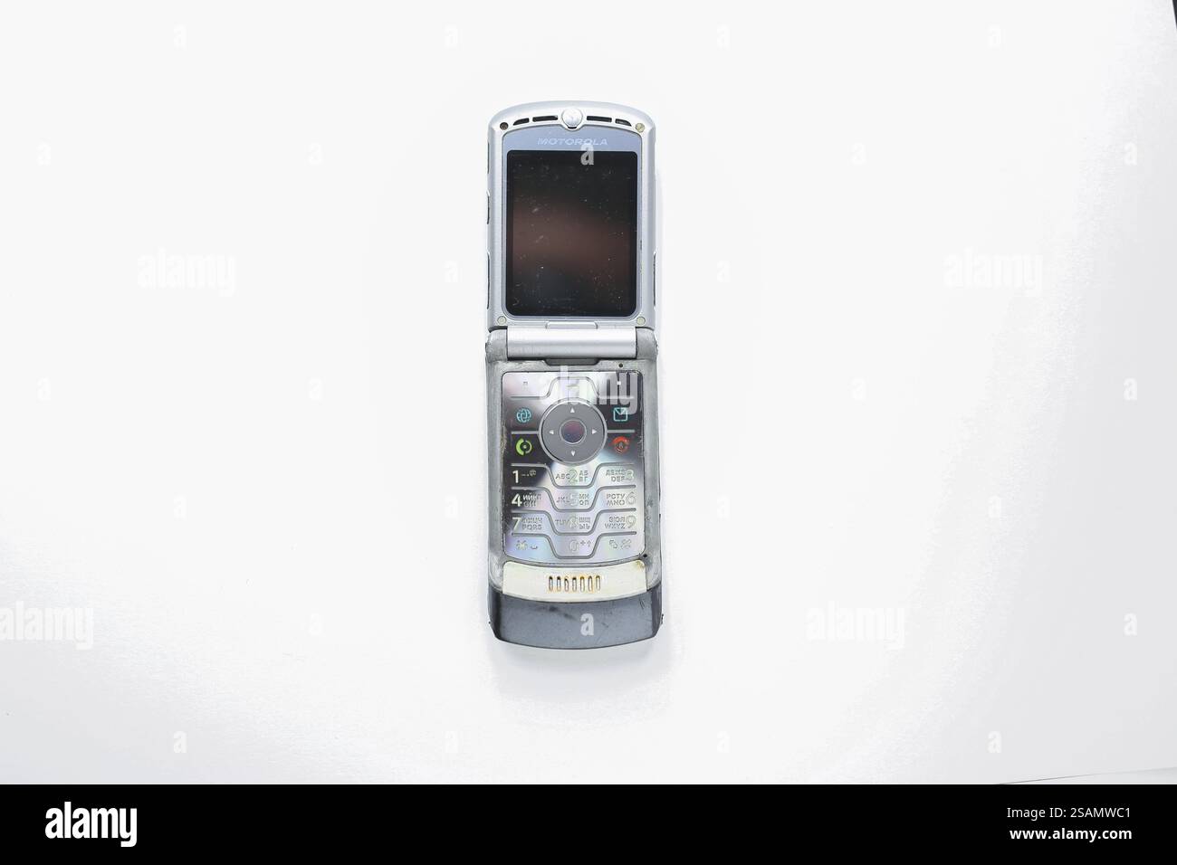 A simple flip phone on a plain white background Stock Photo - Alamy