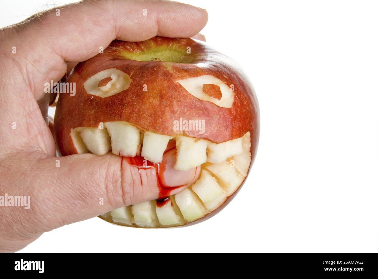 An apple biting the hand that eats it Stock Photo - Alamy
