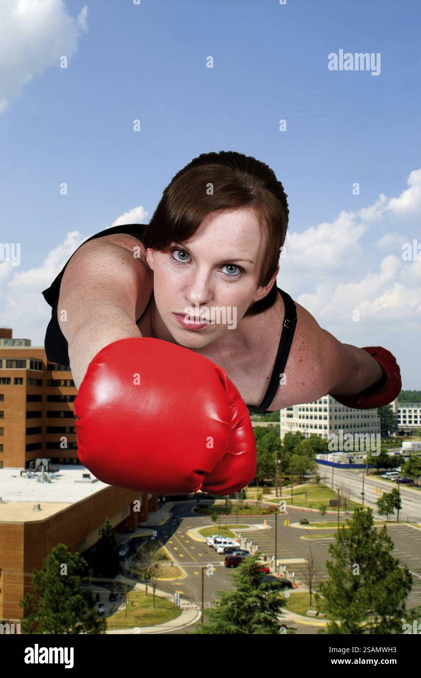 Beautiful woman super hero flying through the sky with boxing gloves ...