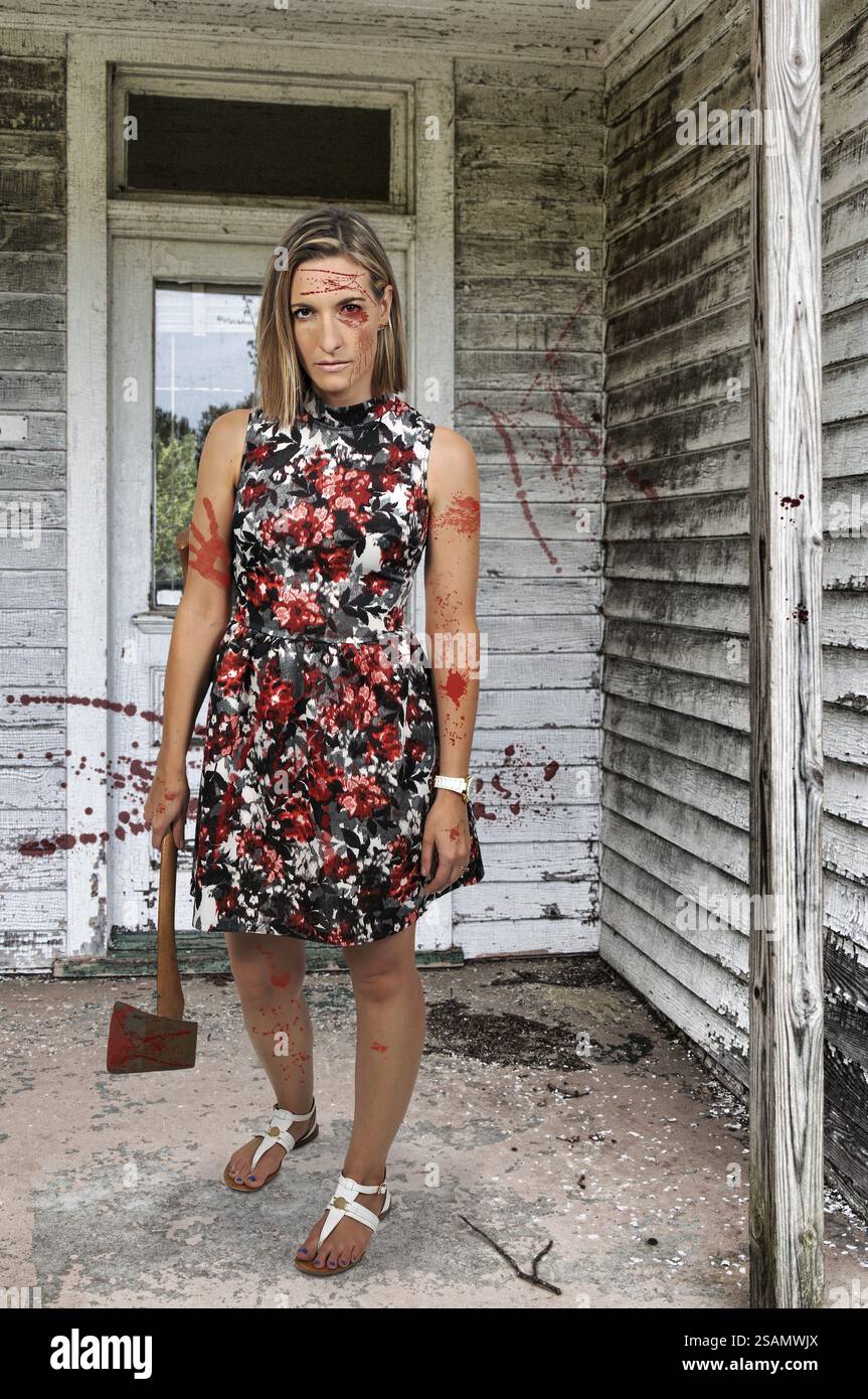 Beautiful possessed woman in a trance holding an axe Stock Photo - Alamy